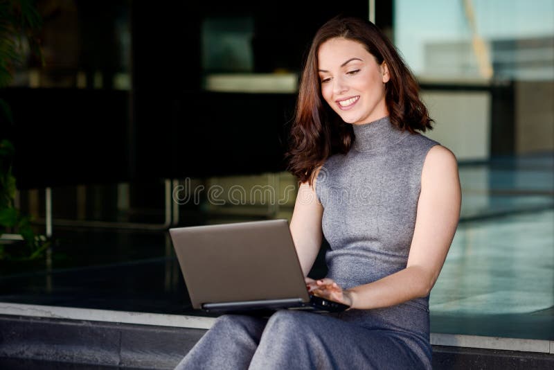 Businesswoman Using Her Laptop Computer in a Modern Office Build Stock ...