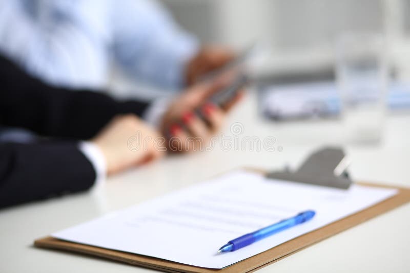 Businesswoman Using Her Phone in Office Sitting on Desk Stock Photo ...