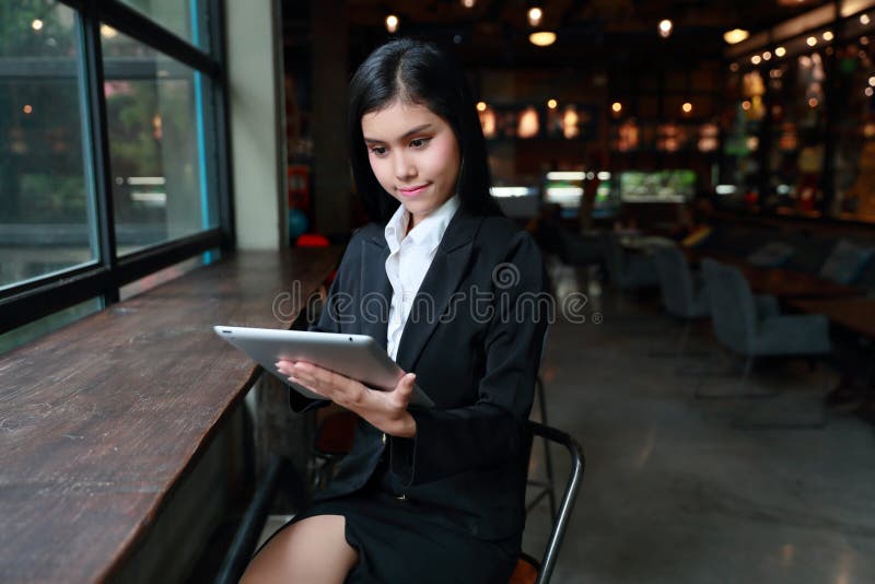 Businesswoman Using Laptop Computer on Table in Cafe Stock Photo ...