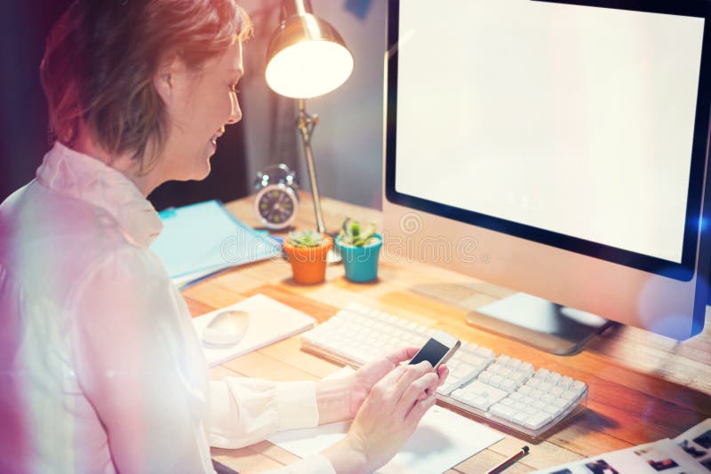 Businesswoman Using Mobile Phone at Desk Stock Photo - Image of happy ...