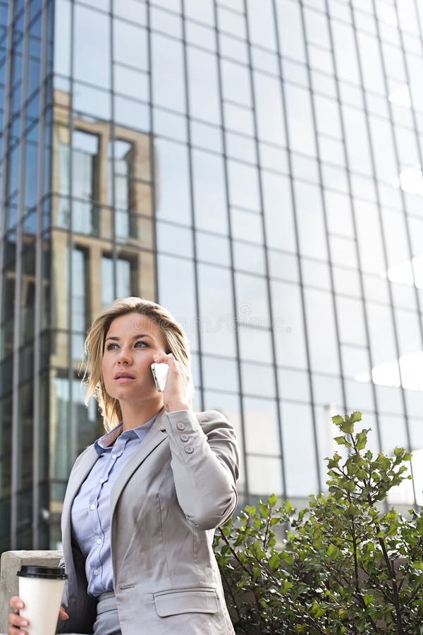 Businesswoman Using Mobile Phone Outside Office Building Stock Photo ...