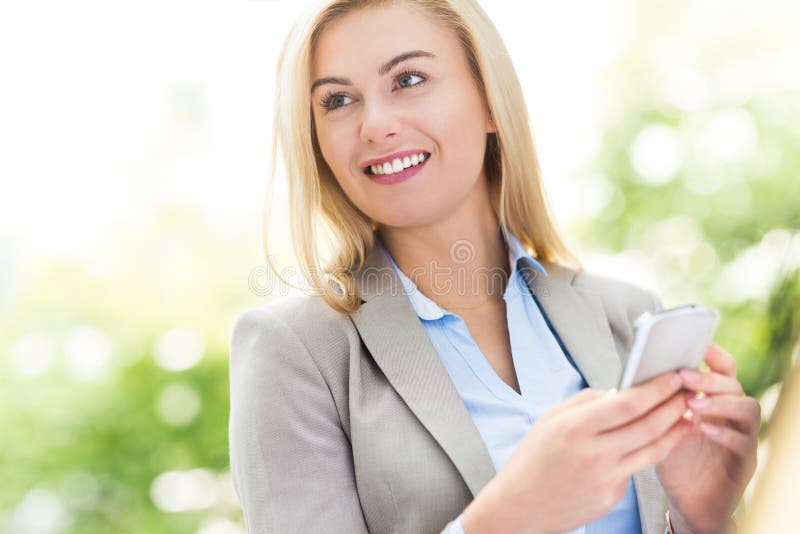 Businesswoman Using a Mobile Phone Stock Photo - Image of corporate ...