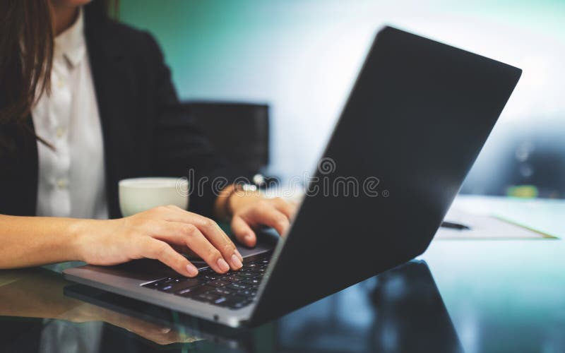 A Businesswoman Using and Typing on Laptop Computer Keyboard while ...