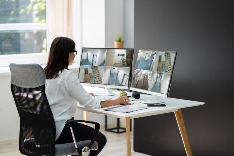 Businesswoman Watching CCTV Footage of Office Interior Stock Photo ...