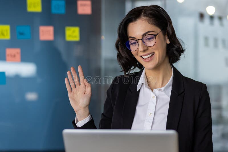 Businesswoman Waving during a Video Call Looking at the Camera in a ...