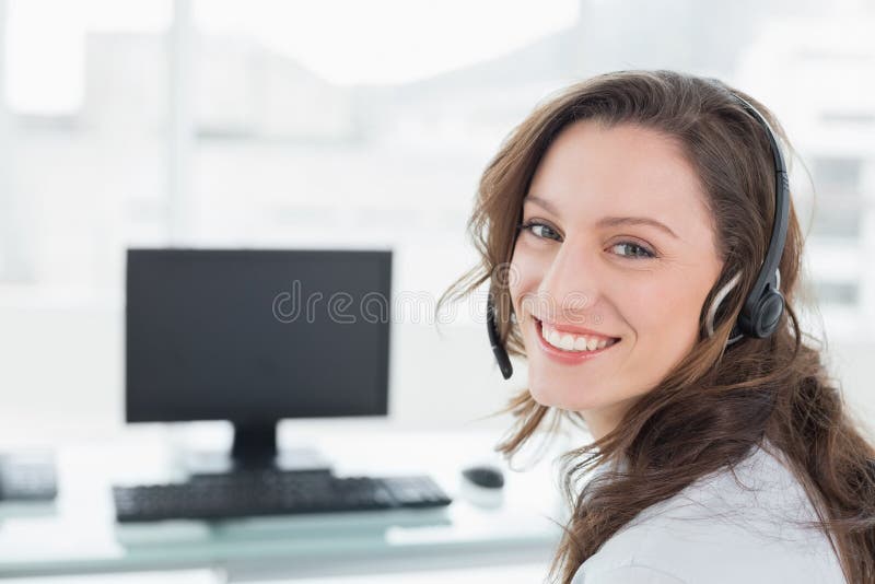 Businesswoman Wearing Headset in Front of Computer in Office Stock ...