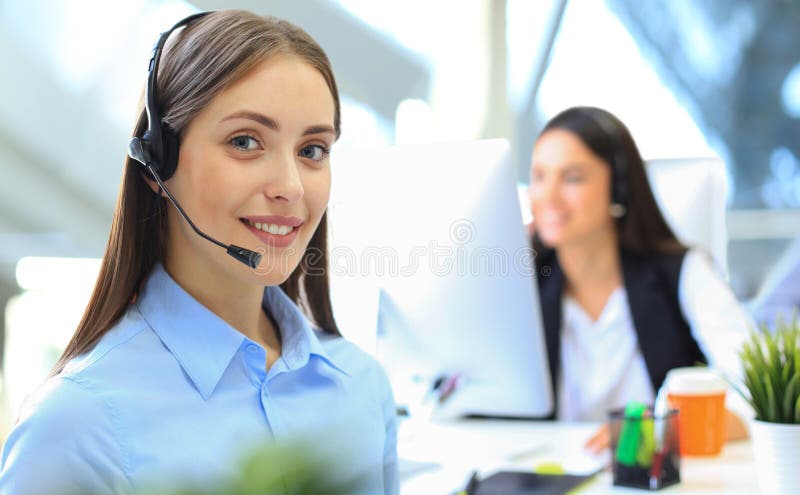 Businesswoman Wearing Microphone Headset Using Computer in the Office ...