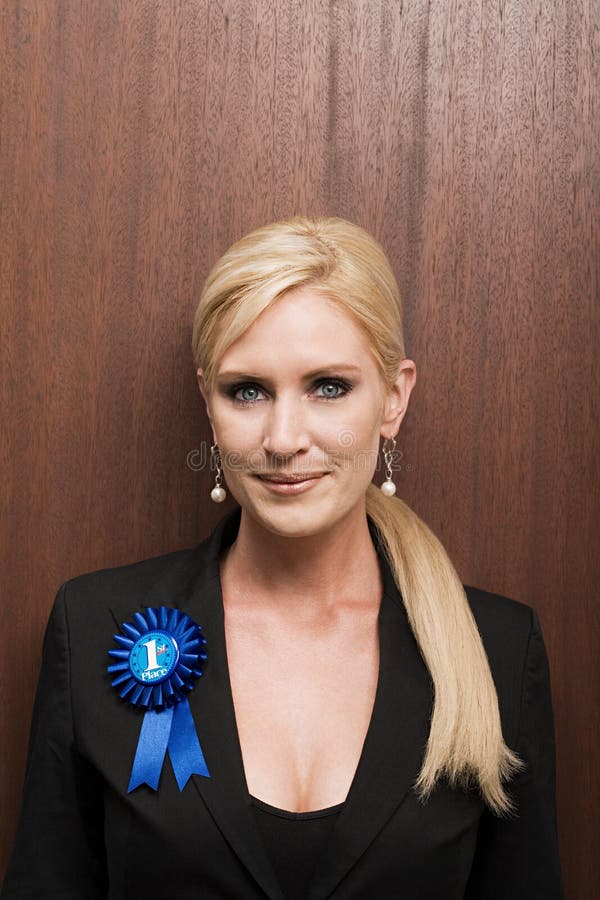 Businesswoman Wearing Rosette Stock Image - Image of blonde, blue: 36095623
