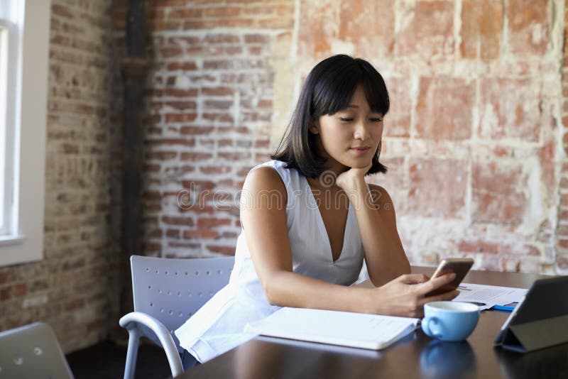 Businesswoman Working in Boardroom and Checking Mobile Phone Stock ...