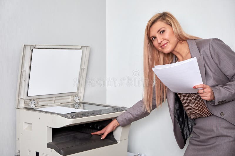 Businesswoman Working on a Copy Machine at the Office Stock Photo ...