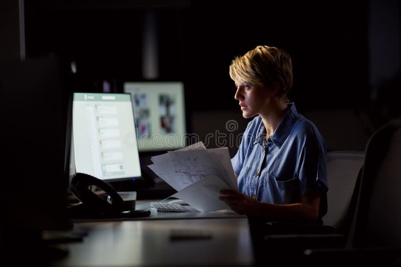 Businesswoman Working Late in Office with Face Illuminated by Computer ...