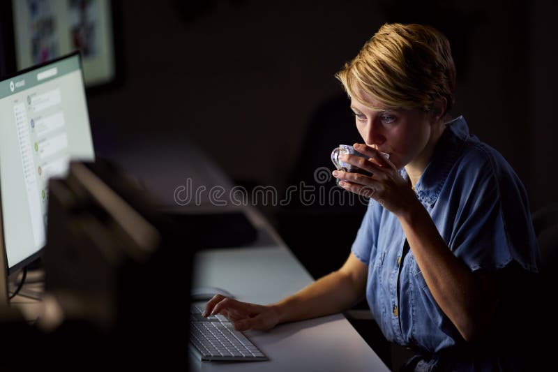 Businesswoman Working Late in Office with Face Illuminated by Computer ...