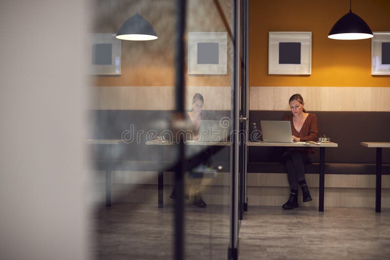 Businesswoman Working Late in Open Plan Office Using Laptop Stock Image ...