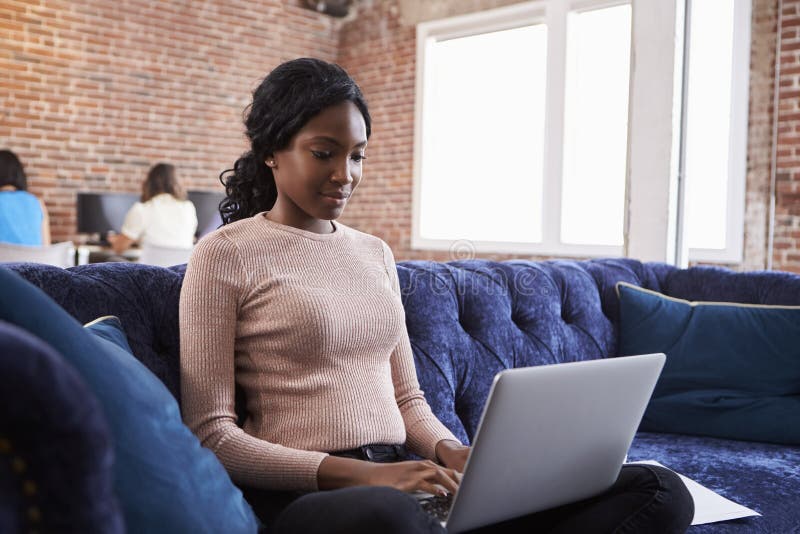 Businesswoman Working on Sofa in Modern Creative Office Stock Photo ...