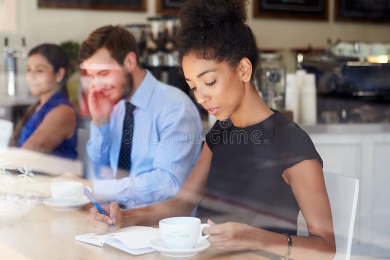 Businesswoman Writing Notes in Coffee Shop Stock Image - Image of happy ...