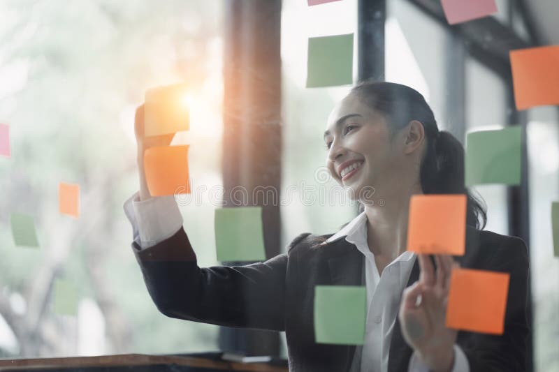 Businesswoman Writing Notes about Teamwork Decisions for Project Plan ...