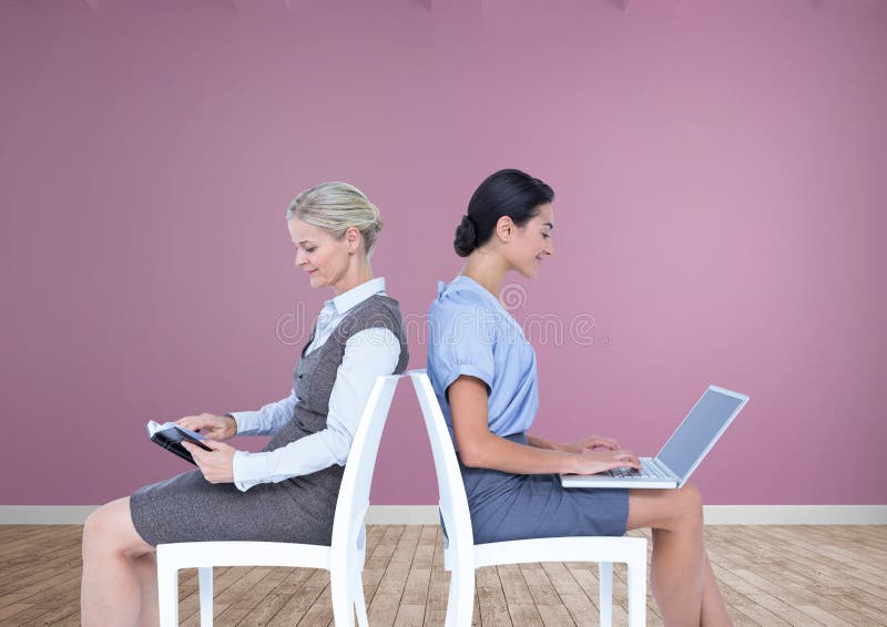 Businesswomen Collaborating Working Back To Back on Chairs Stock Image ...