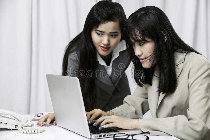 Businesswomen Discussing on Computer Stock Photo - Image of arms ...