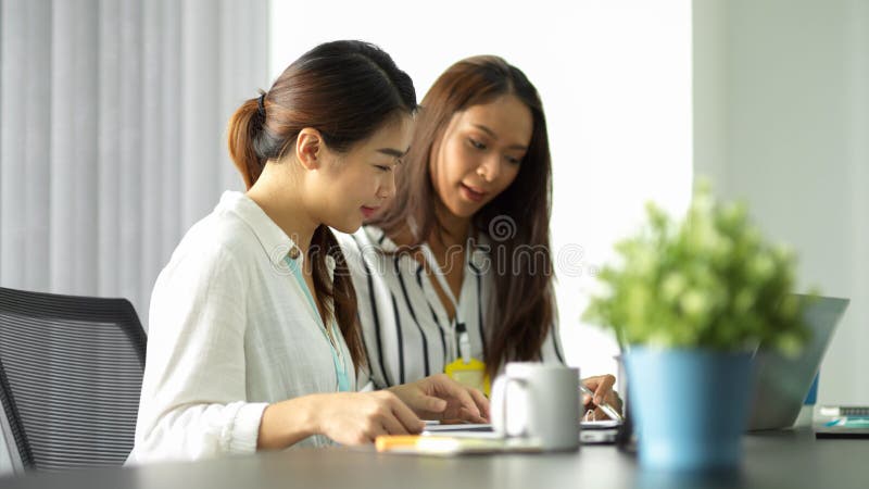 Businesswomen in the Office Discussing a Project Assignment Stock Photo ...