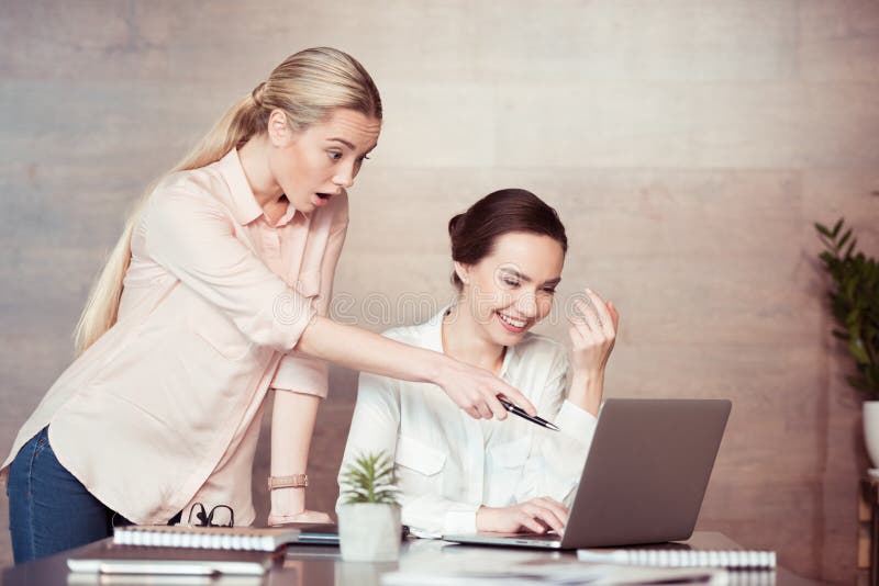 Businesswomen Using Laptop and Pointing with Pen at Screen Stock Image ...