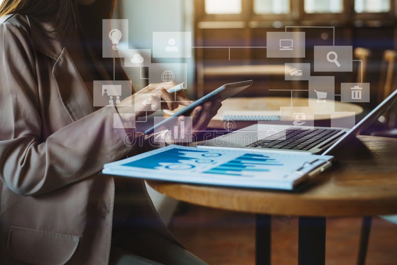 Businesswomen Using Tablet with Laptop and Document on Desk in Modern ...