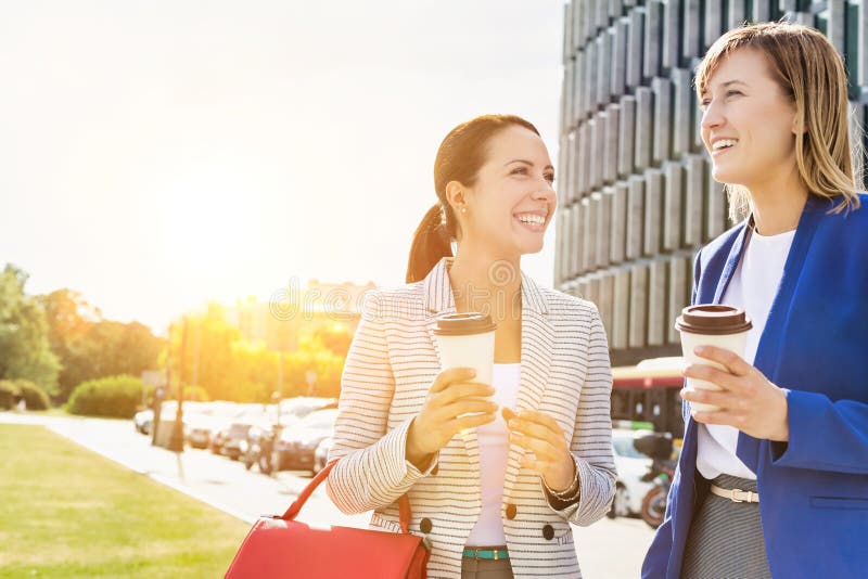 Businesswomen Walking while Talking Outside Office Building Stock Photo ...