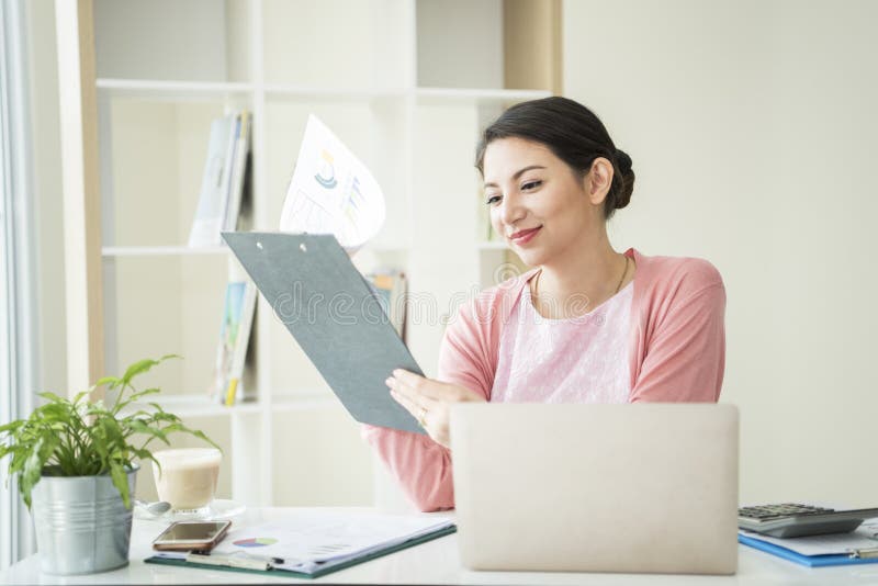 Businesswomen Working and Analyzing Financial Figures on a Graph Stock ...