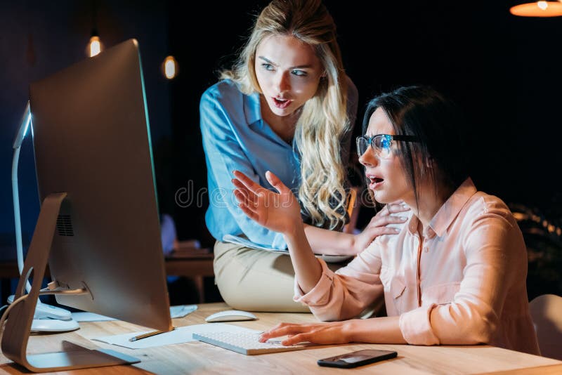 Businesswomen Working on Computer while Discussing New Project Together ...