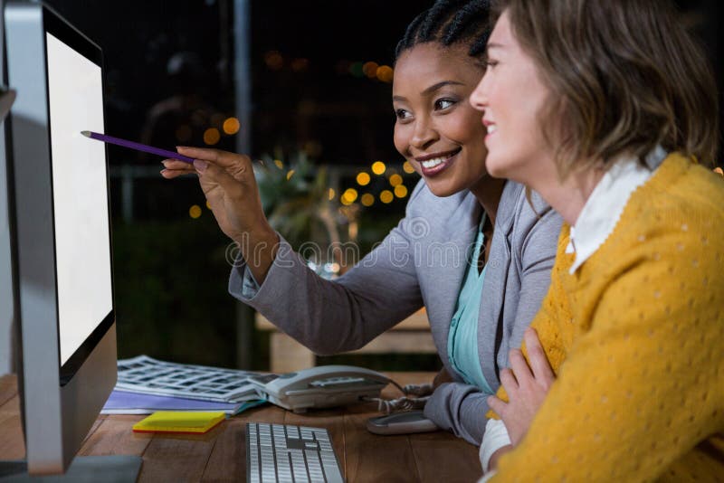Businesswomen Working on Computer at Their Desk Stock Image - Image of ...