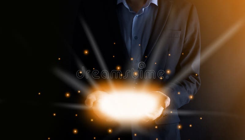 Businness Man Holding Hands Open with Glowing Lights on Dark Background ...