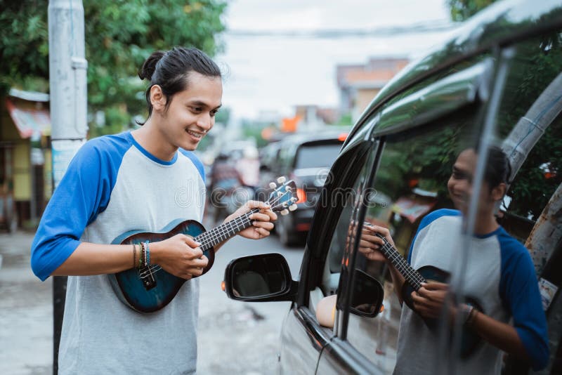 Busker Use Musical Instruments and Sing beside a Car Stock Image ...