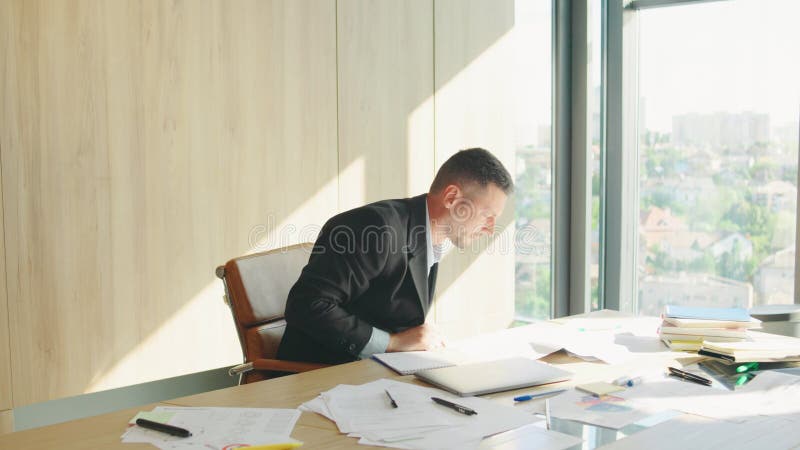 In a Bustling Corporate Office, a Stressed Businessman is Surrounded by ...