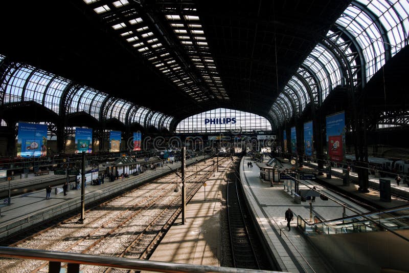 A Group of Train Platforms and Some People Walking Around it Editorial ...