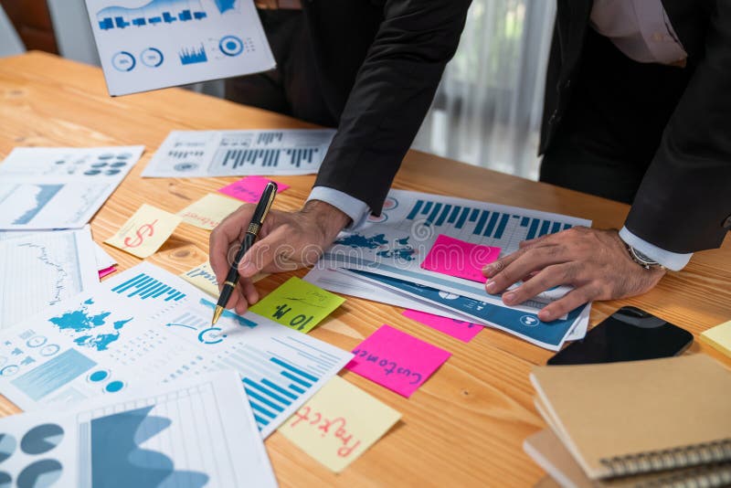 Busy Analyst Team in Office Discuss Data Analysis on Tablet Screen ...