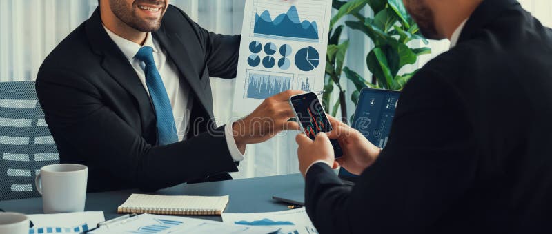 Busy Analyst Team Discussing Financial Data on Laptop and Phone ...