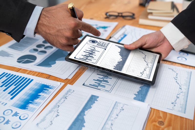 Busy Analyst Team Discussing Financial Data on Tablet. Fervent Stock ...