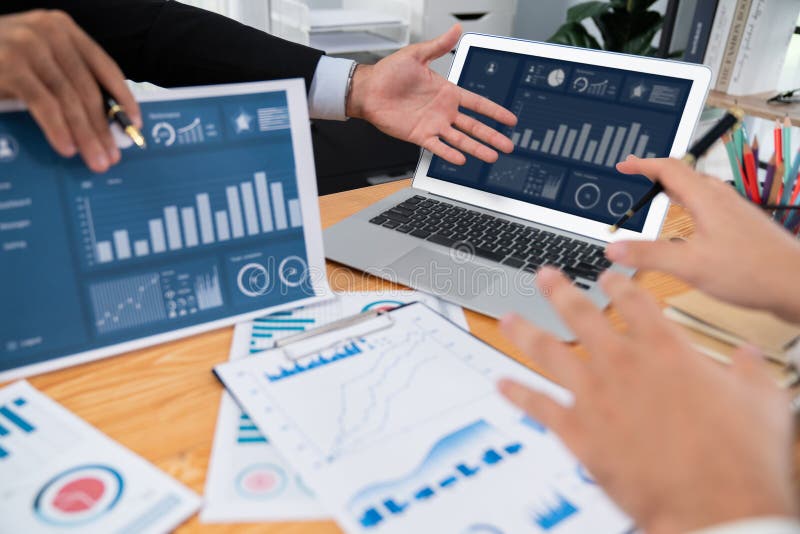 Busy Analyst Team Discussing Financial Data on Laptop. Fervent Stock ...