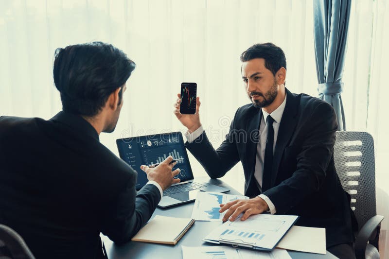 Busy Analyst Team Discussing Financial Data on Laptop. Fervent Stock ...