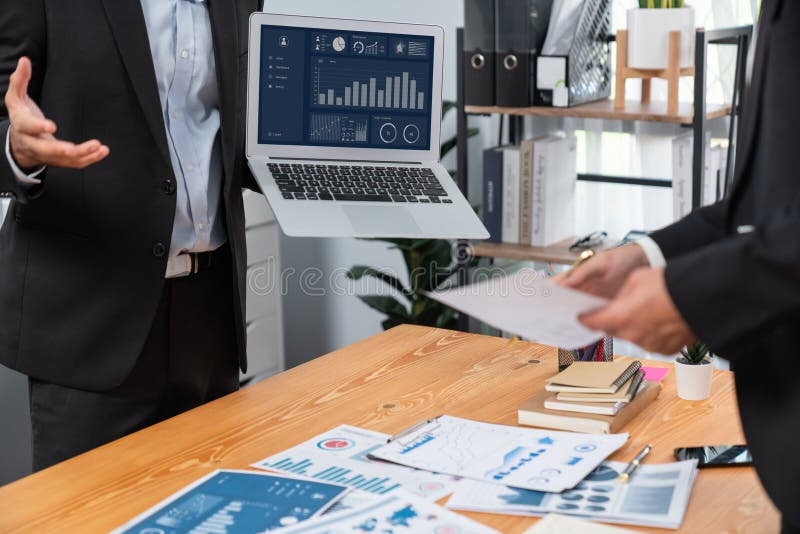 Busy Analyst Team Discussing Financial Data on Laptop. Fervent Stock ...