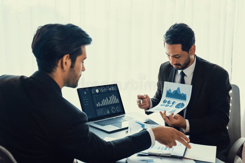 Busy Analyst Team Discussing Financial Data on Laptop. Fervent Stock ...