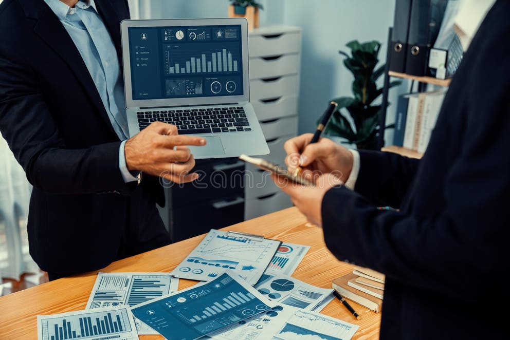 Busy Analyst Team Discussing Financial Data on Laptop. Fervent Stock ...