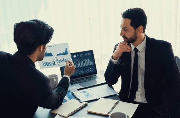 Busy Analyst Team Discussing Financial Data on Laptop. Fervent Stock ...
