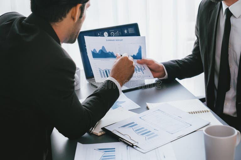 Busy Analyst Team Discussing Financial Data on Laptop. Fervent Stock ...