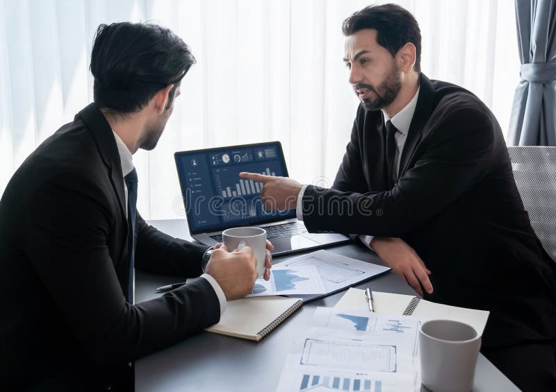 Busy Analyst Team Discussing Financial Data on Laptop. Fervent Stock ...