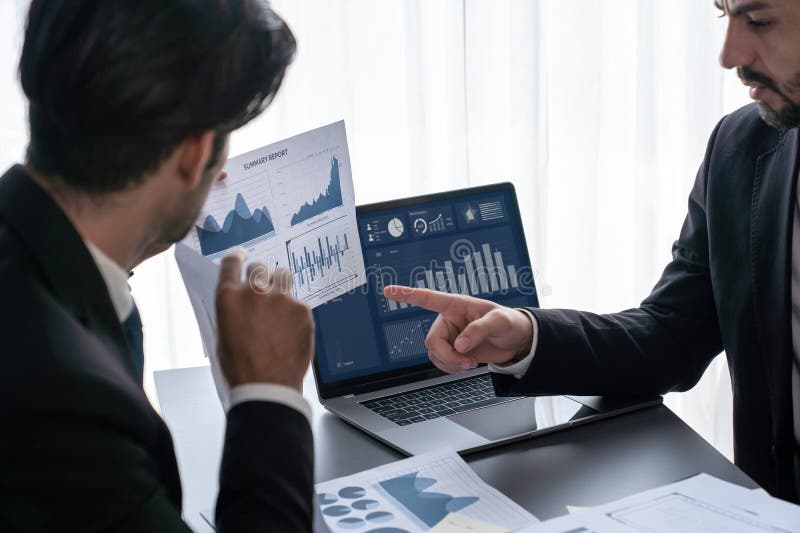 Busy Analyst Team Discussing Financial Data on Laptop. Fervent Stock ...