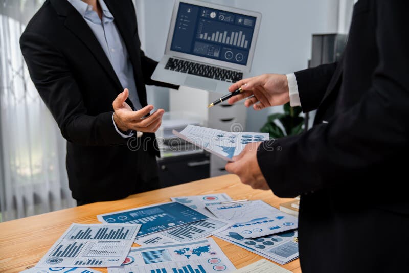 Busy Analyst Team Discussing Financial Data on Laptop. Fervent Stock ...