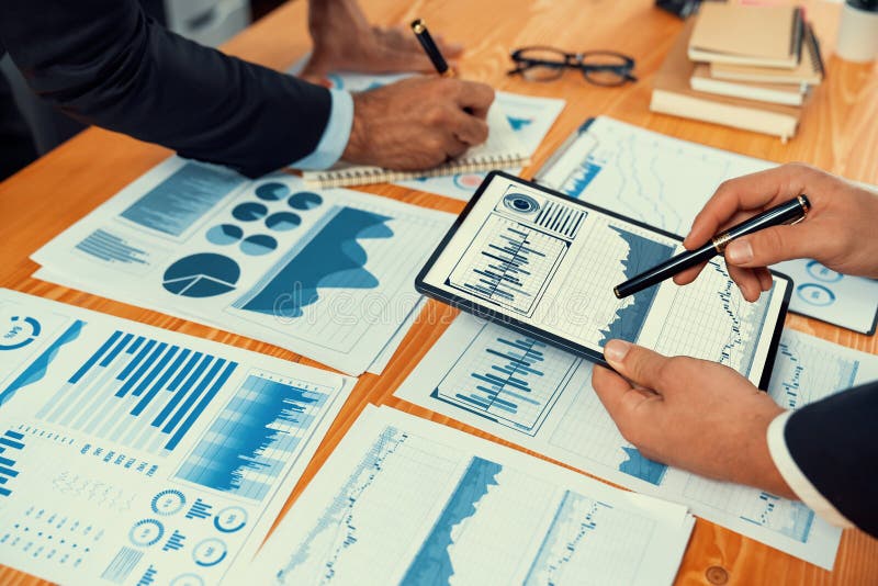 Busy Analyst Team Discussing Financial Data on Tablet. Fervent Stock ...