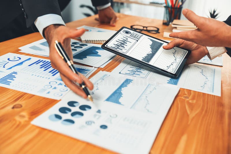 Busy Analyst Team Discussing Financial Data on Tablet. Fervent Stock ...