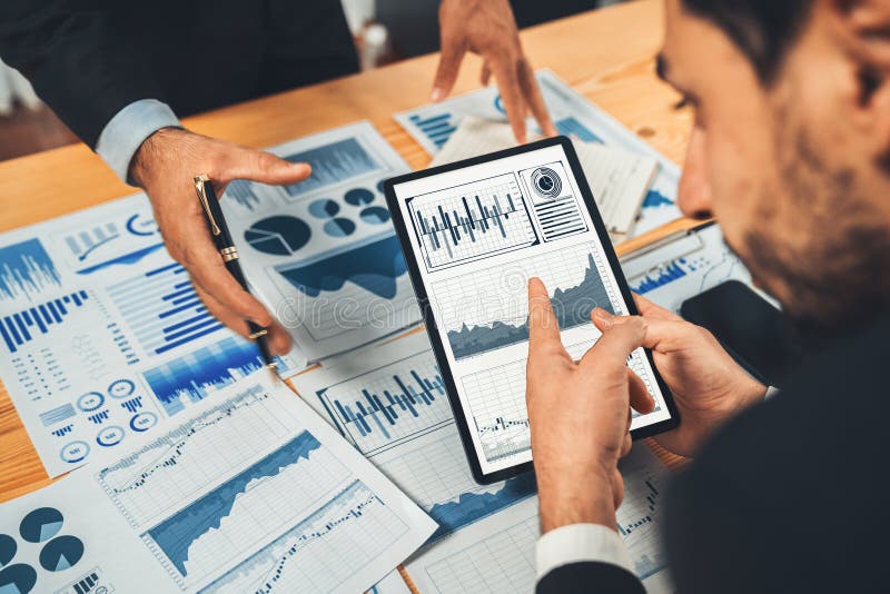 Busy Analyst Team Discussing Financial Data on Tablet. Fervent Stock ...