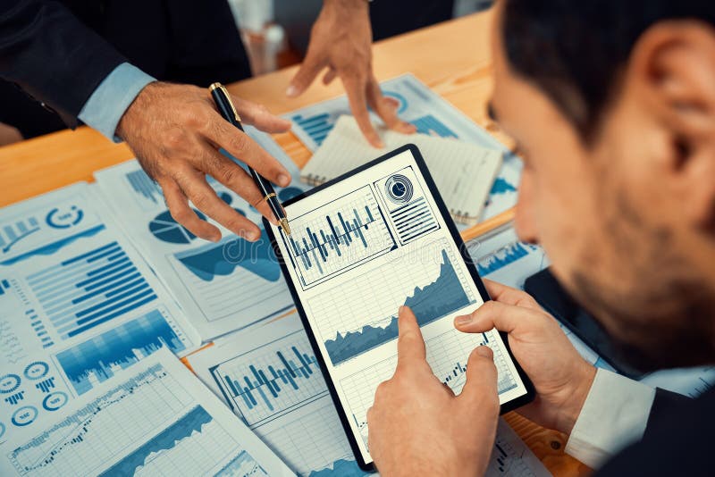 Busy Analyst Team Discussing Financial Data on Tablet. Fervent Stock ...